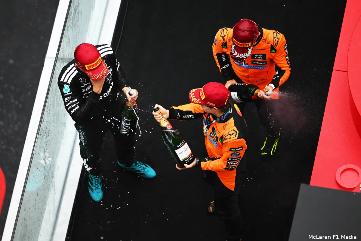 champagne podium george russell lando norris oscar piastri