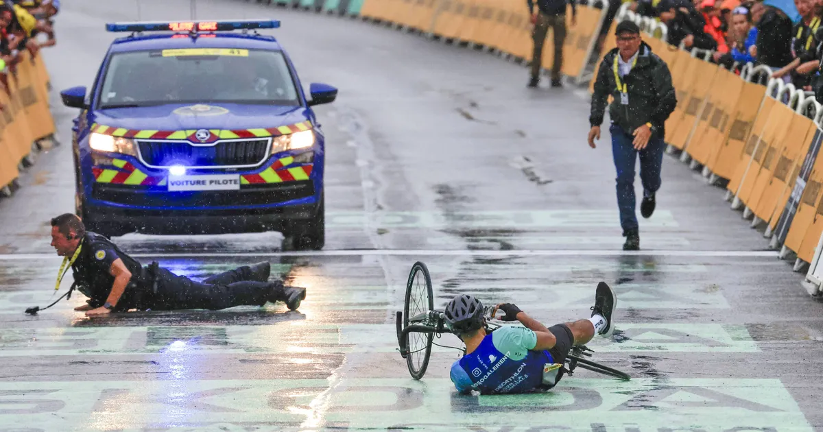 PHOTOS: Police tackle Tour de France on-bike spectator 1 minute before ...