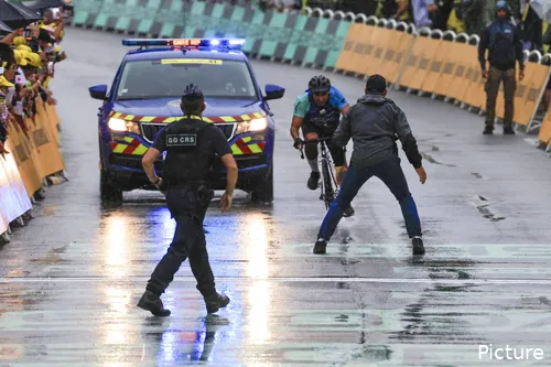 PHOTOS: Police tackle Tour de France on-bike spectator 1 minute before ...
